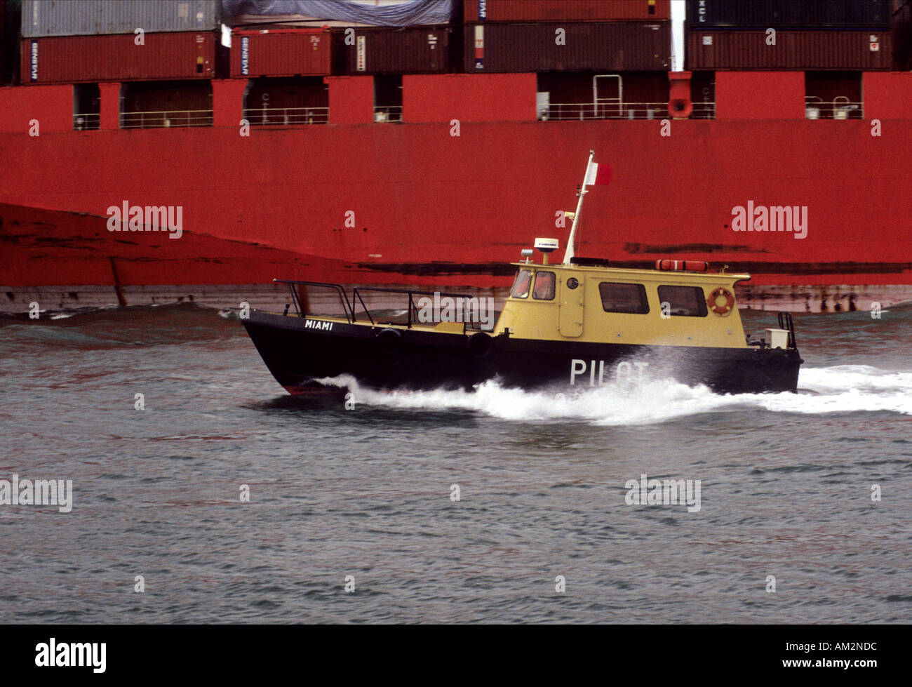 A pilot boat guiding a freighter Stock Photo - Alamy