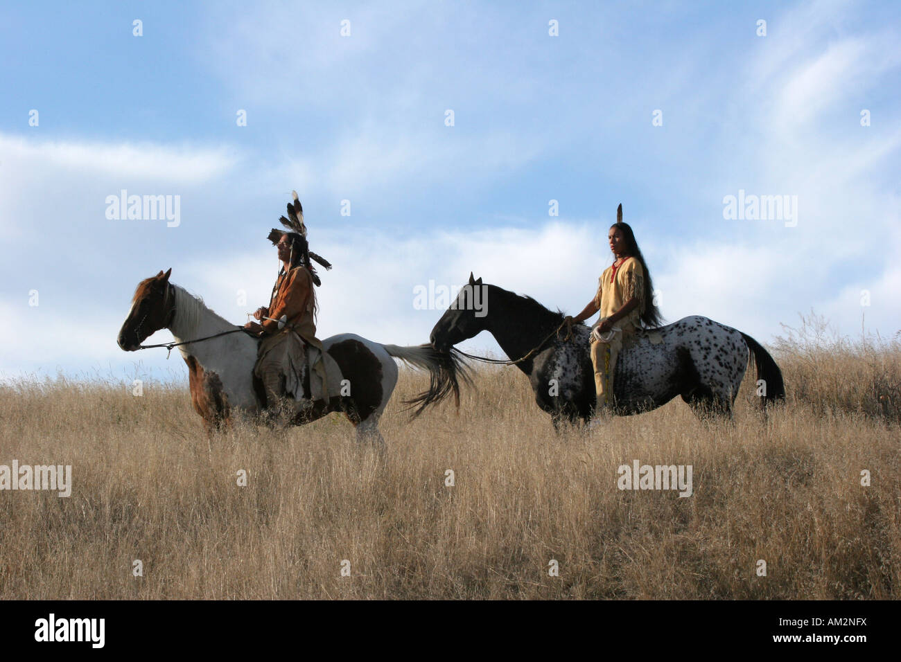 Two Native American Indian men sitting bareback on a horse in ...