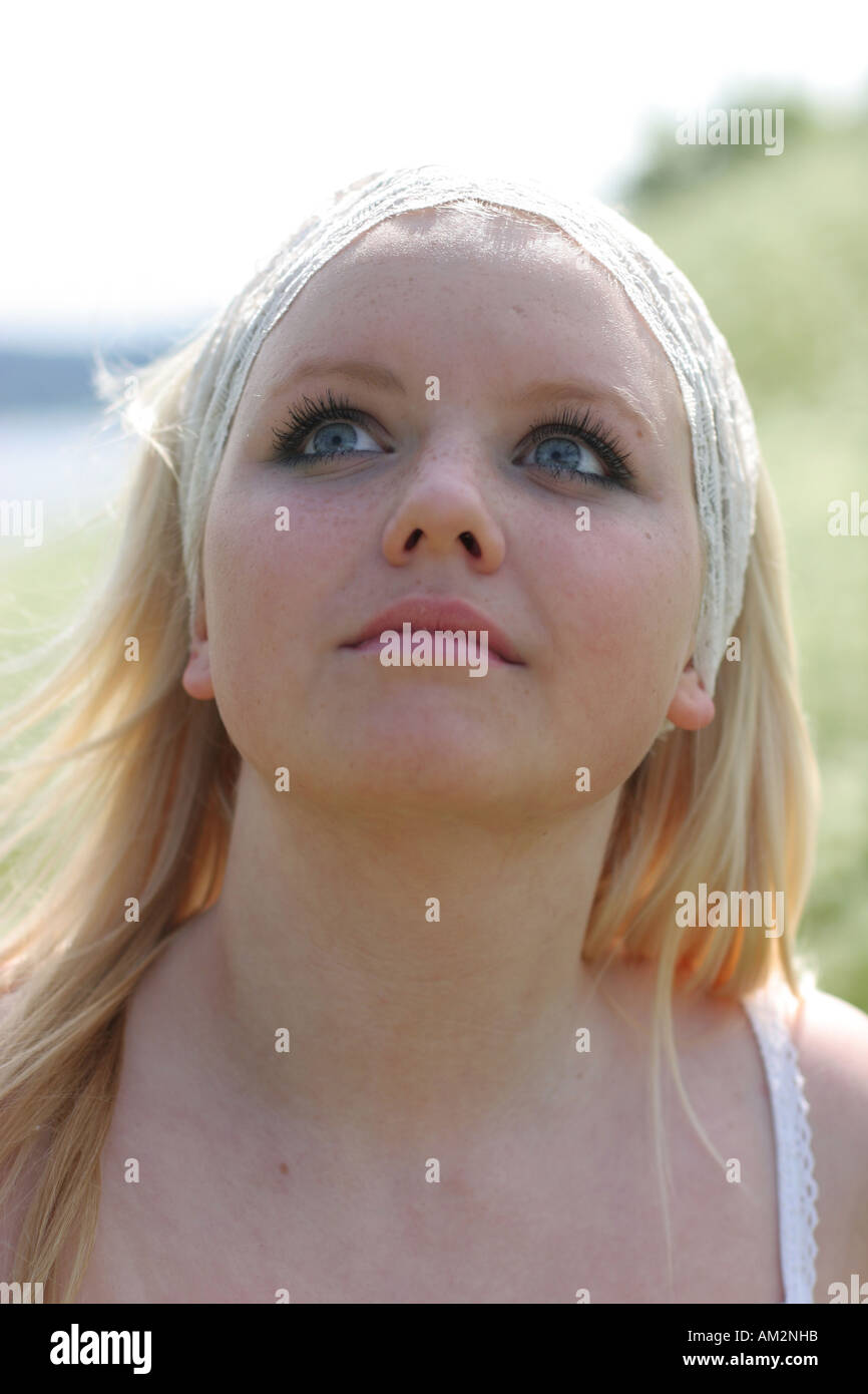 headshot pretty young girl playing outside in the nature summer breeze ...