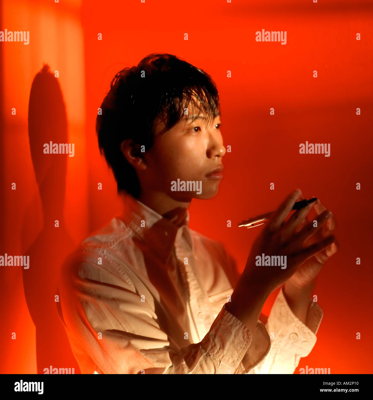 A businessman student at a meeting with walls of robust orange color ...