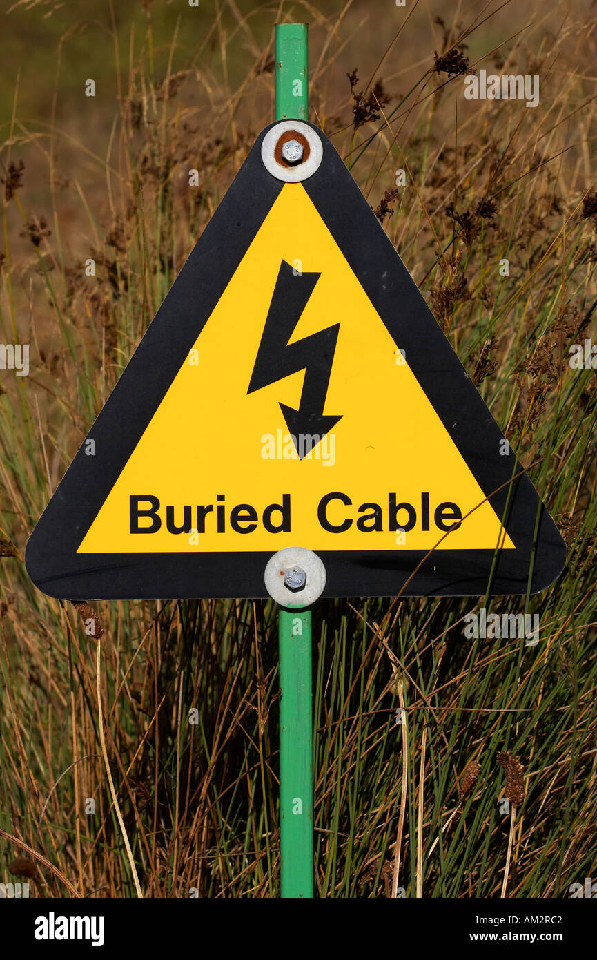 Yellow buried electrical cable warning sign at a quarry in the west ...