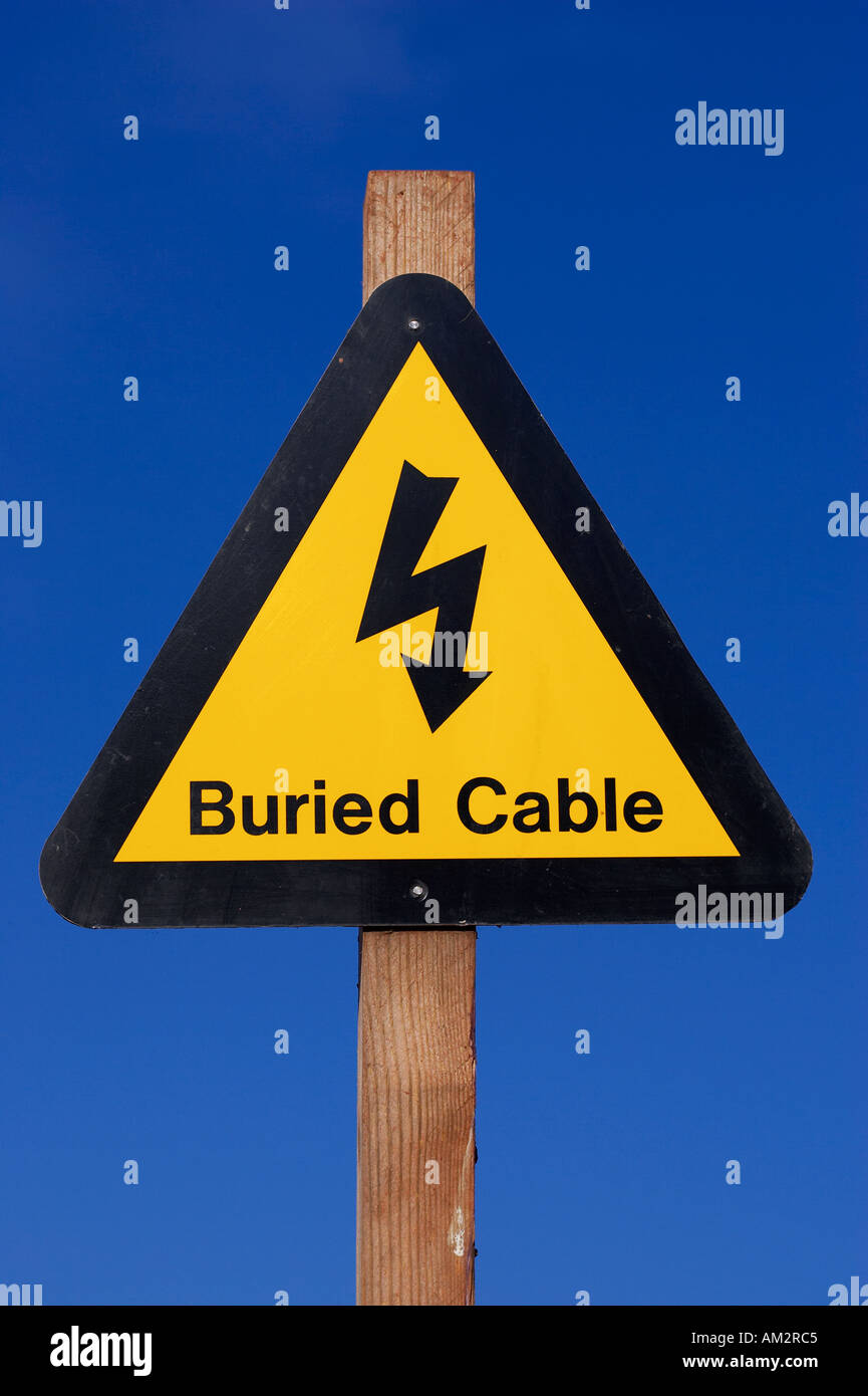 Yellow buried electrical cable warning sign at a quarry in the west ...