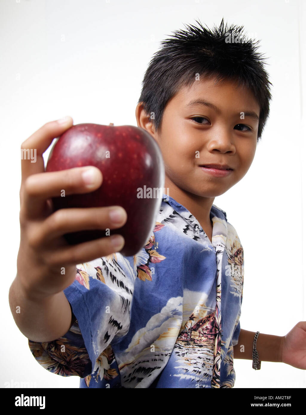 Kid offering apple Stock Photo - Alamy