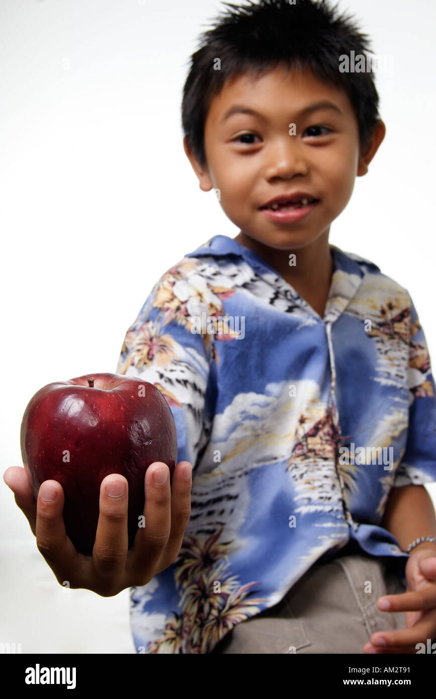 Kid offering apple Stock Photo - Alamy