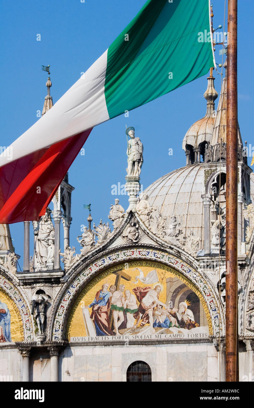 Italian flag and the Basilica San Marco in the Piazza San Marco Venice ...