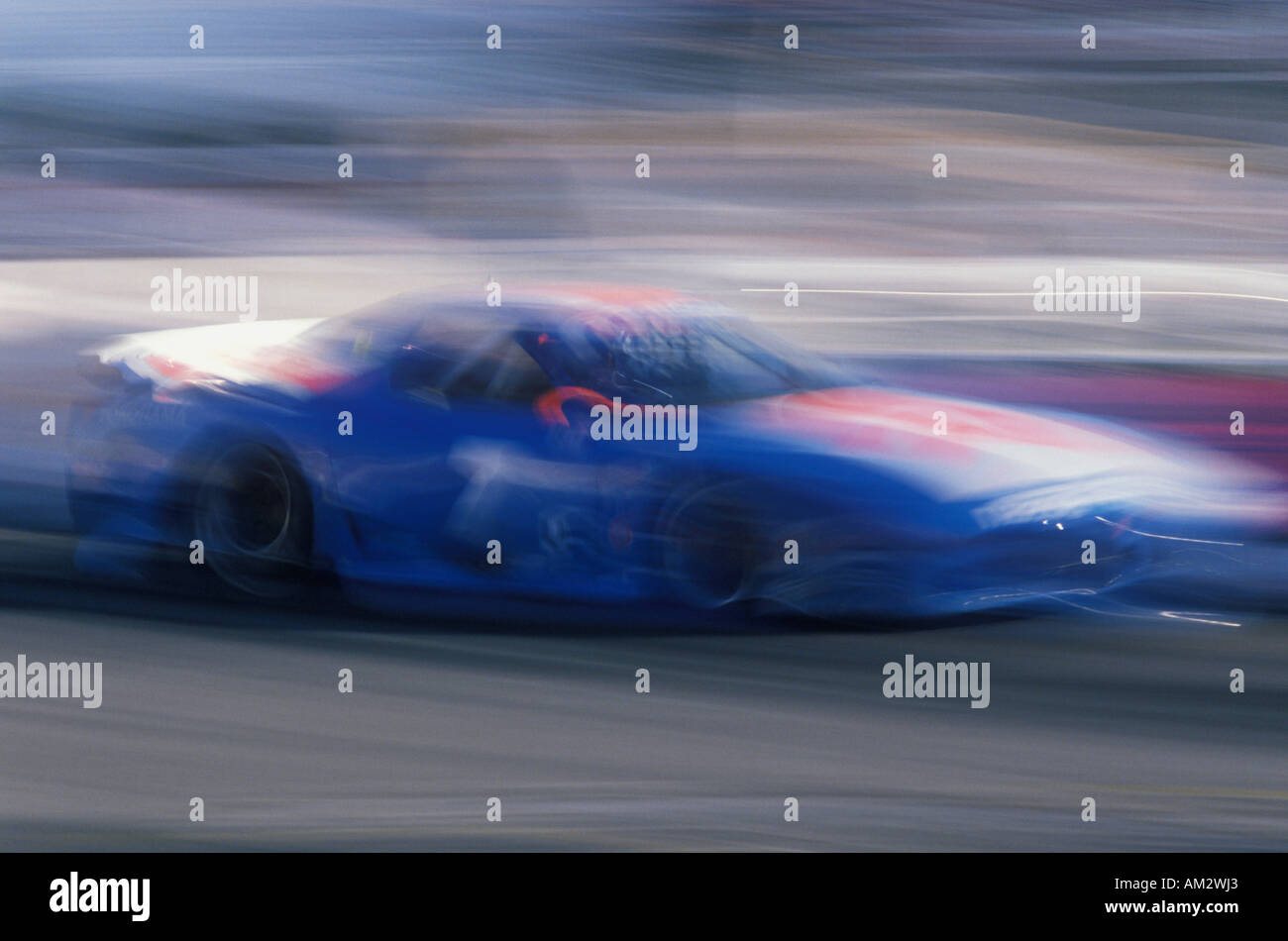 A blue Mazda in the Toyota Grand Prix Race at the Indy Car World Series ...