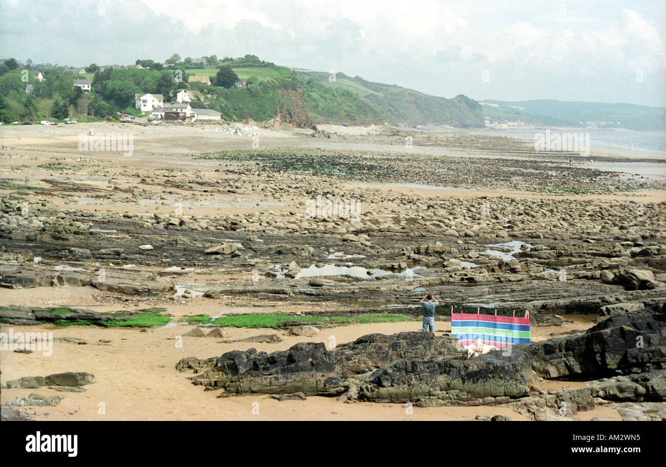 View across the beach at Wiseman s Bridge lone holidaymaker with ...