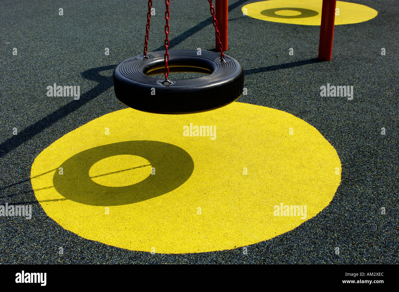 Playground tire swing with safety circle Stock Photo - Alamy