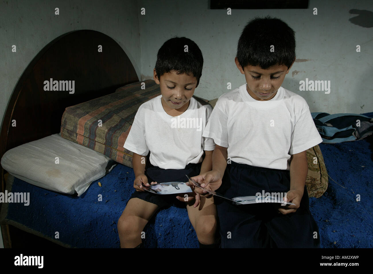 Two Guarani boys looking at pictures in the poor area of Chacarita ...