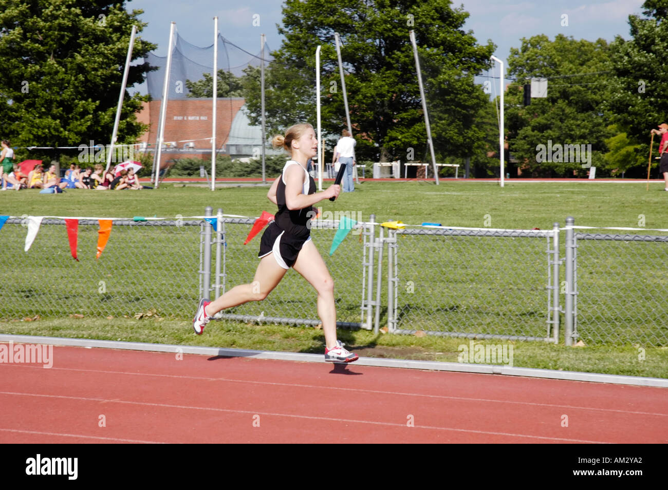 Teenage girl relay race runners at a high school track and field ...