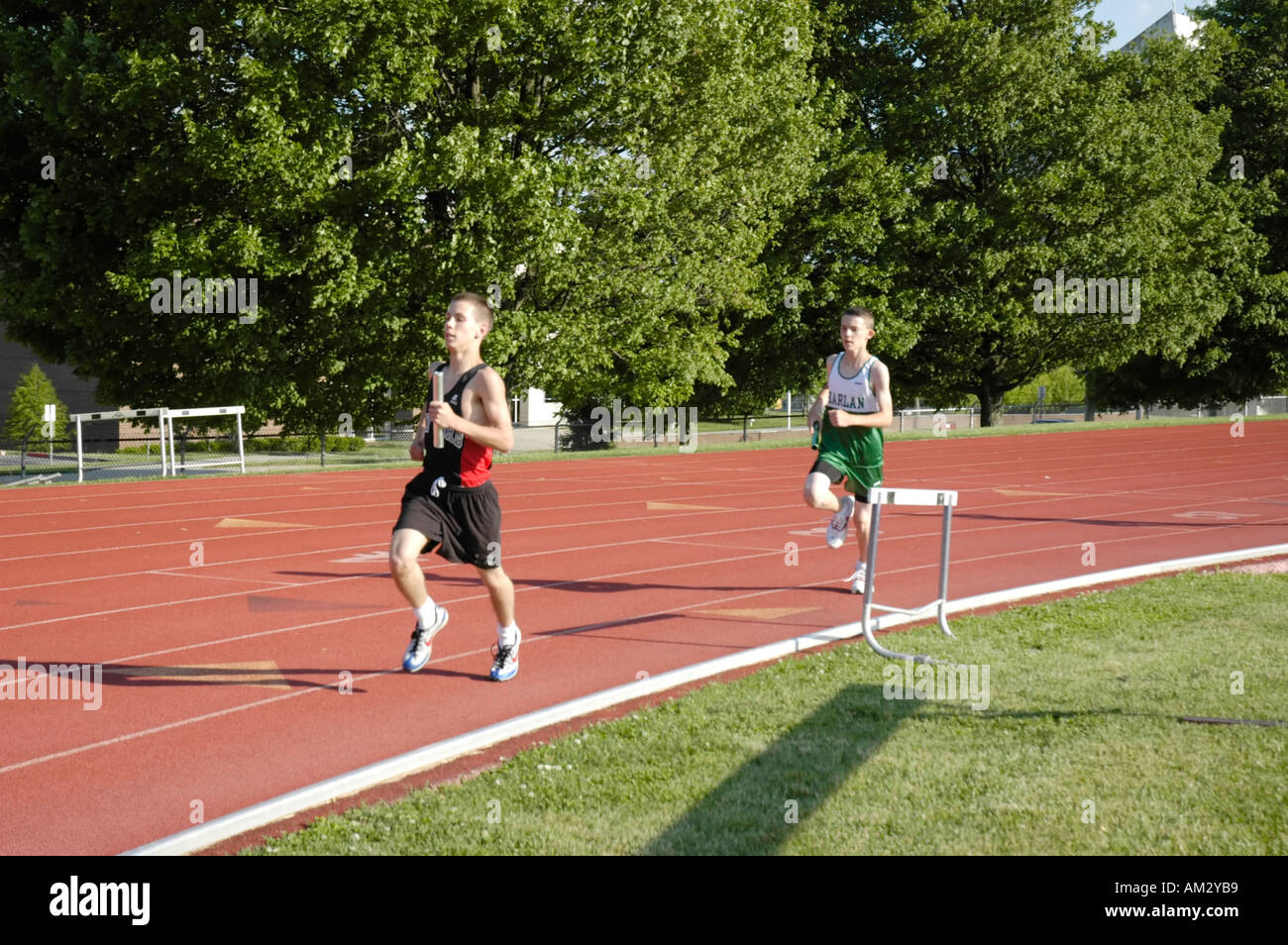 Teenage boy runners at a high school track and field district meet ...