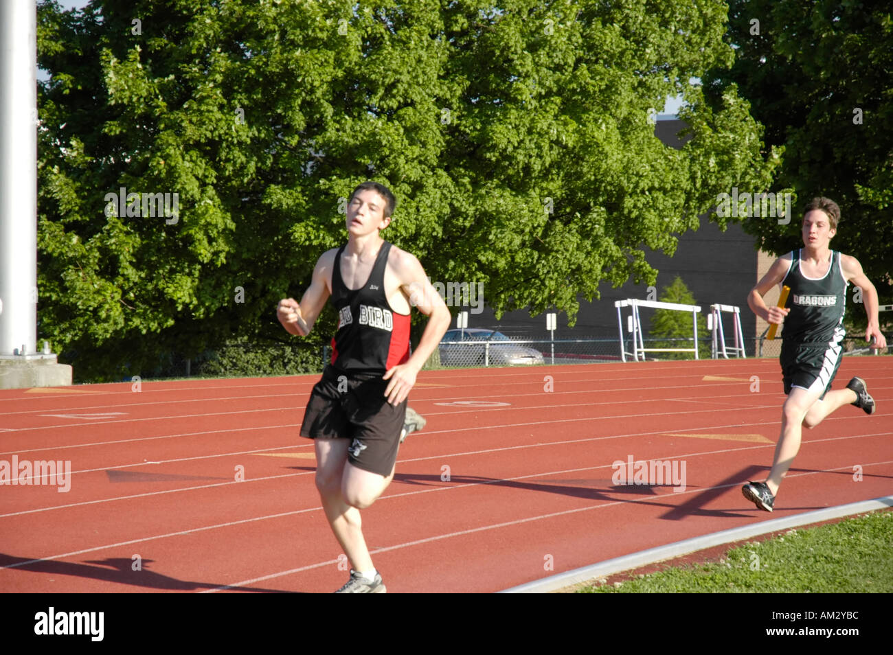 Teenage boy runners at a high school track and field district meet ...