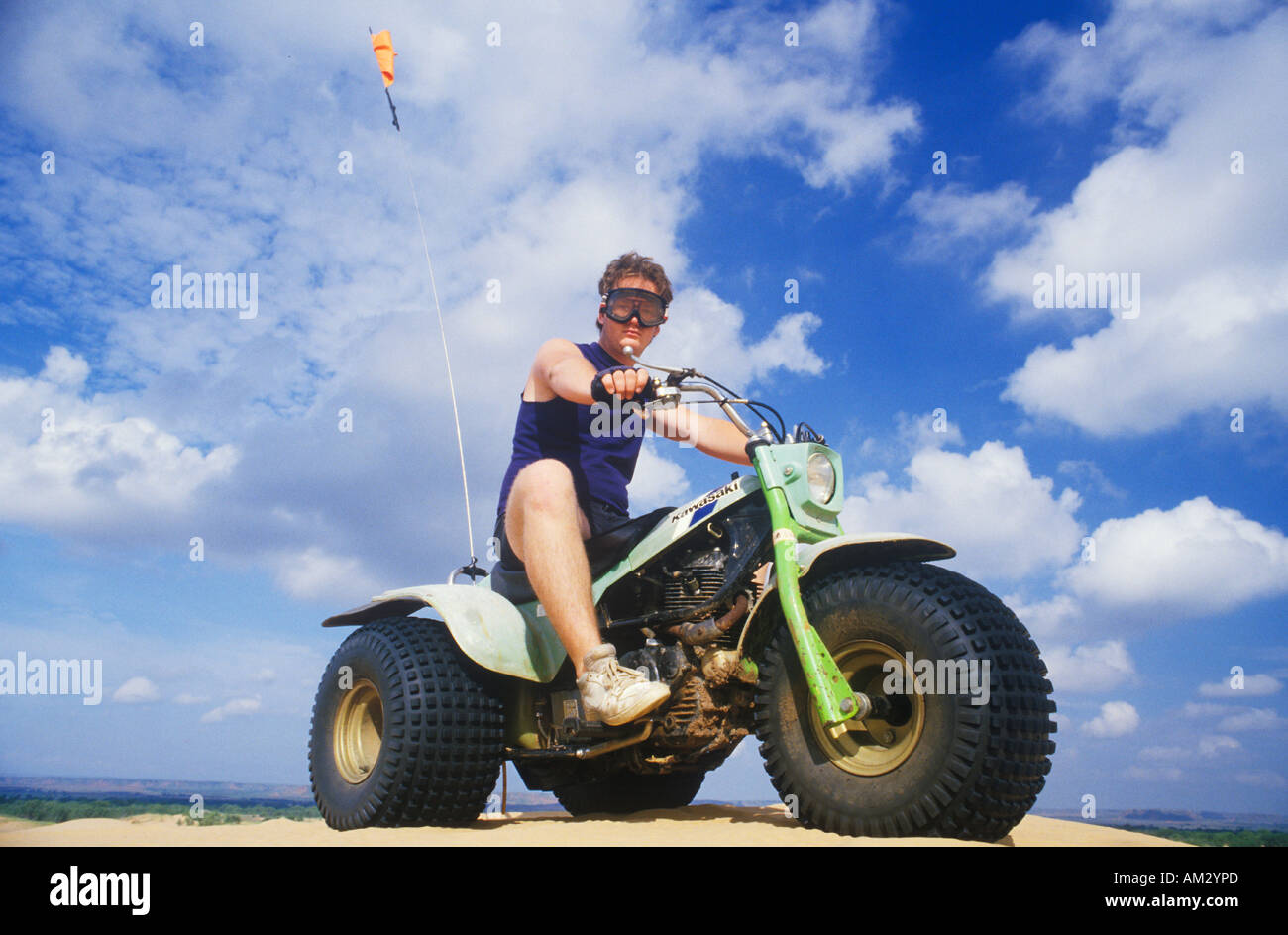 A man astride a 3 wheeled recreational vehicle in Little Sahara State ...