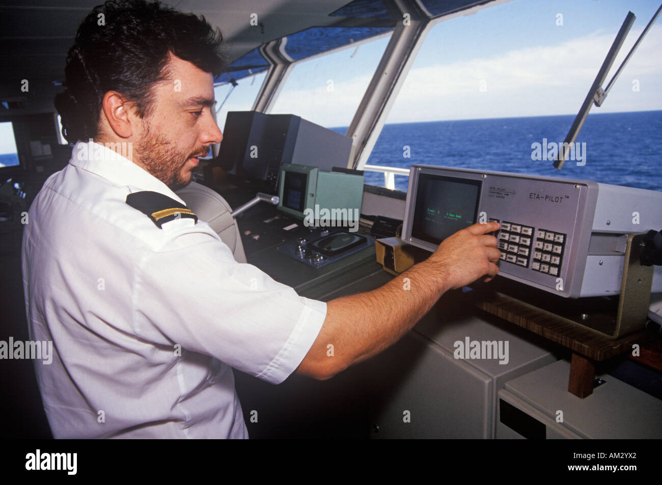A crew member of the ferry Bluenose piloting the ship through the ...