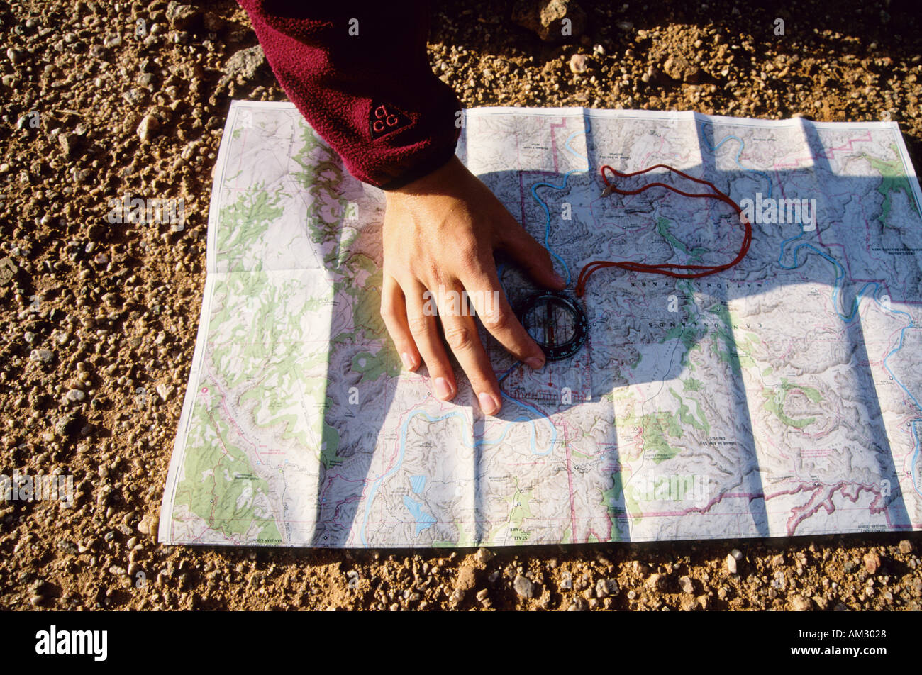 A man reading a compass and a map Stock Photo - Alamy