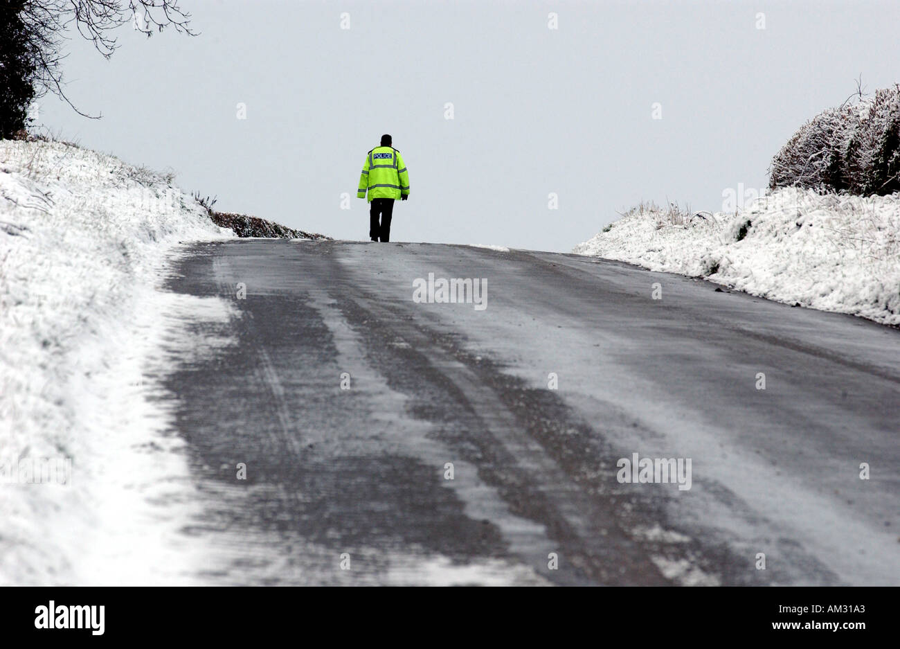 A Traffic Police Officer on an icy country road in the south of Britain ...