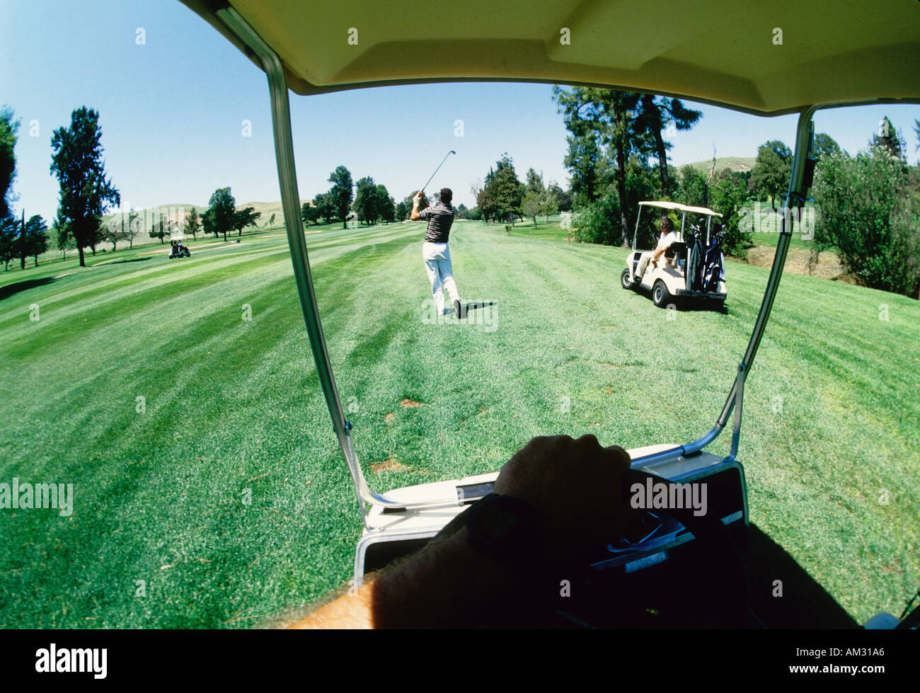 Golf players driving cart hi-res stock photography and images - Alamy