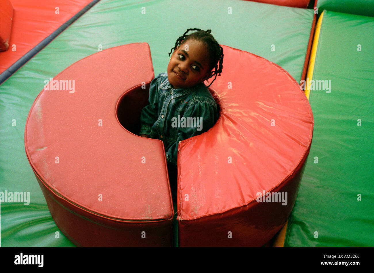 Young girl playing in soft play area at nursery Stock Photo - Alamy