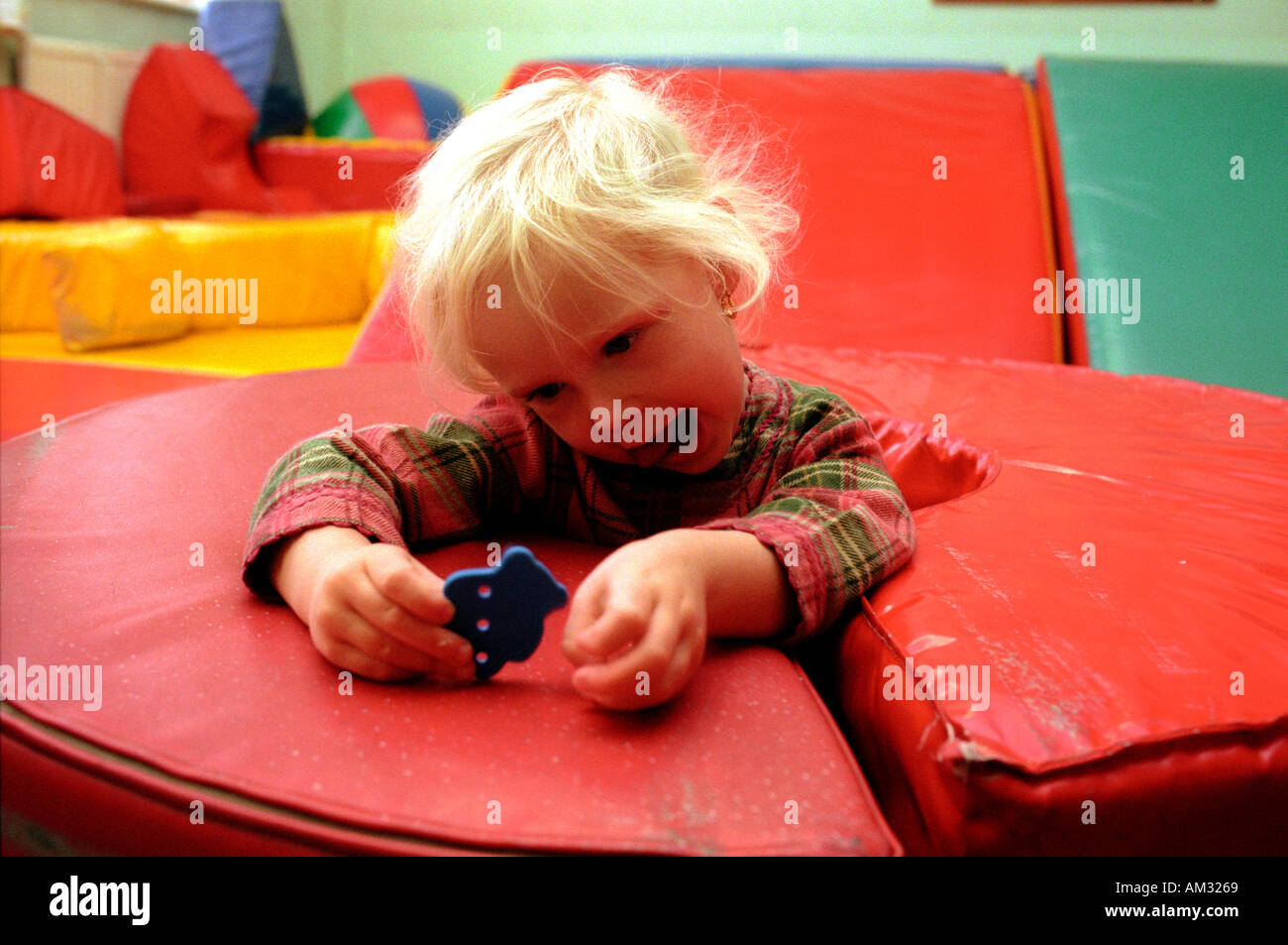 Young girl playing in soft play area at nursery Stock Photo - Alamy