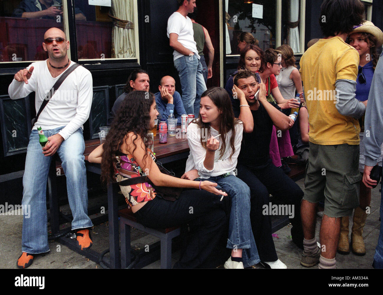 Group of young people chatting outside at pub Stock Photo - Alamy