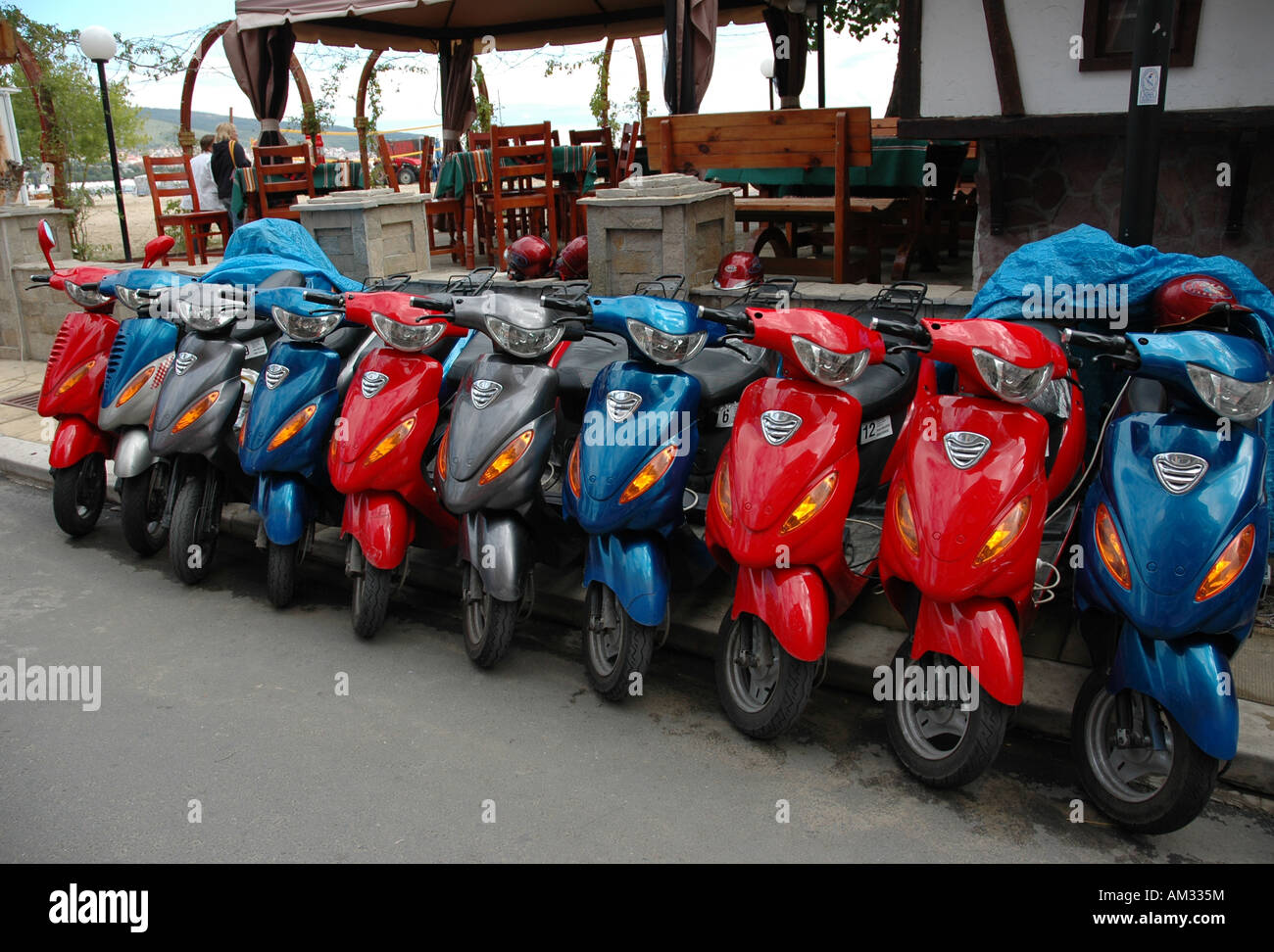 Coloured scooters in a row Stock Photo - Alamy