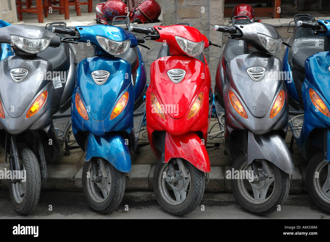 Coloured scooters in a row Stock Photo - Alamy
