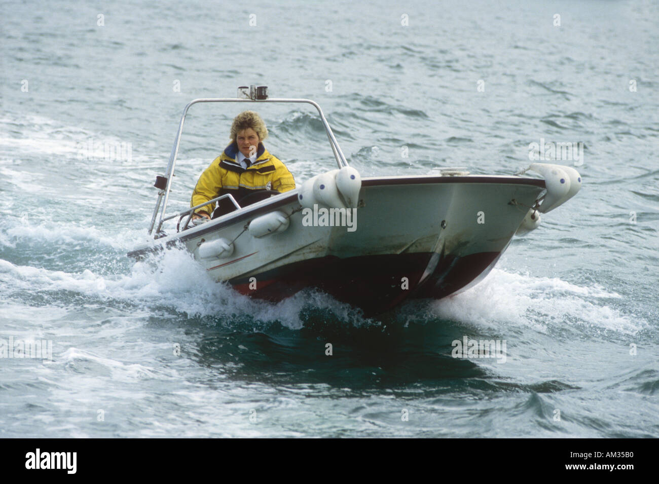 A Customs and Excise officer patrols the marina at Yarmouth Isle of ...
