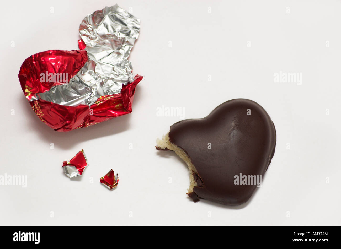 Still life of unwrapped foil and chocolate with missing bite Stock ...