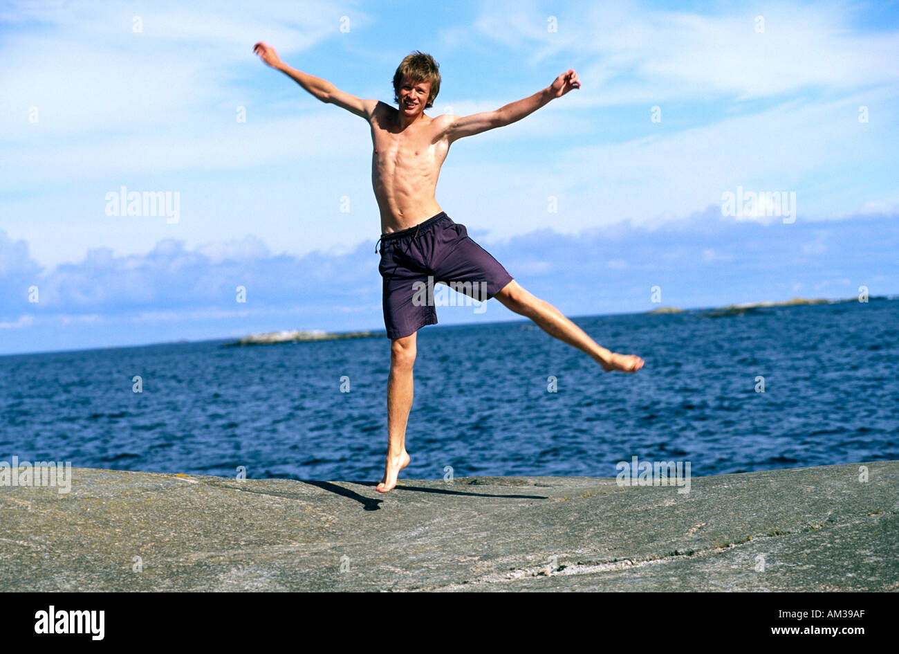 Boy jumping at beach Stock Photo - Alamy