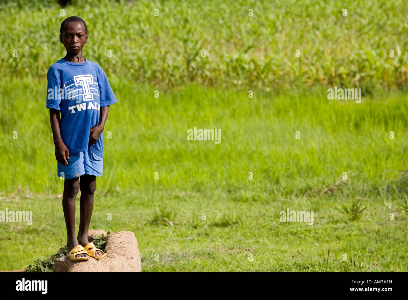 A young Ghanaian boy stands on a rock Stock Photo - Alamy