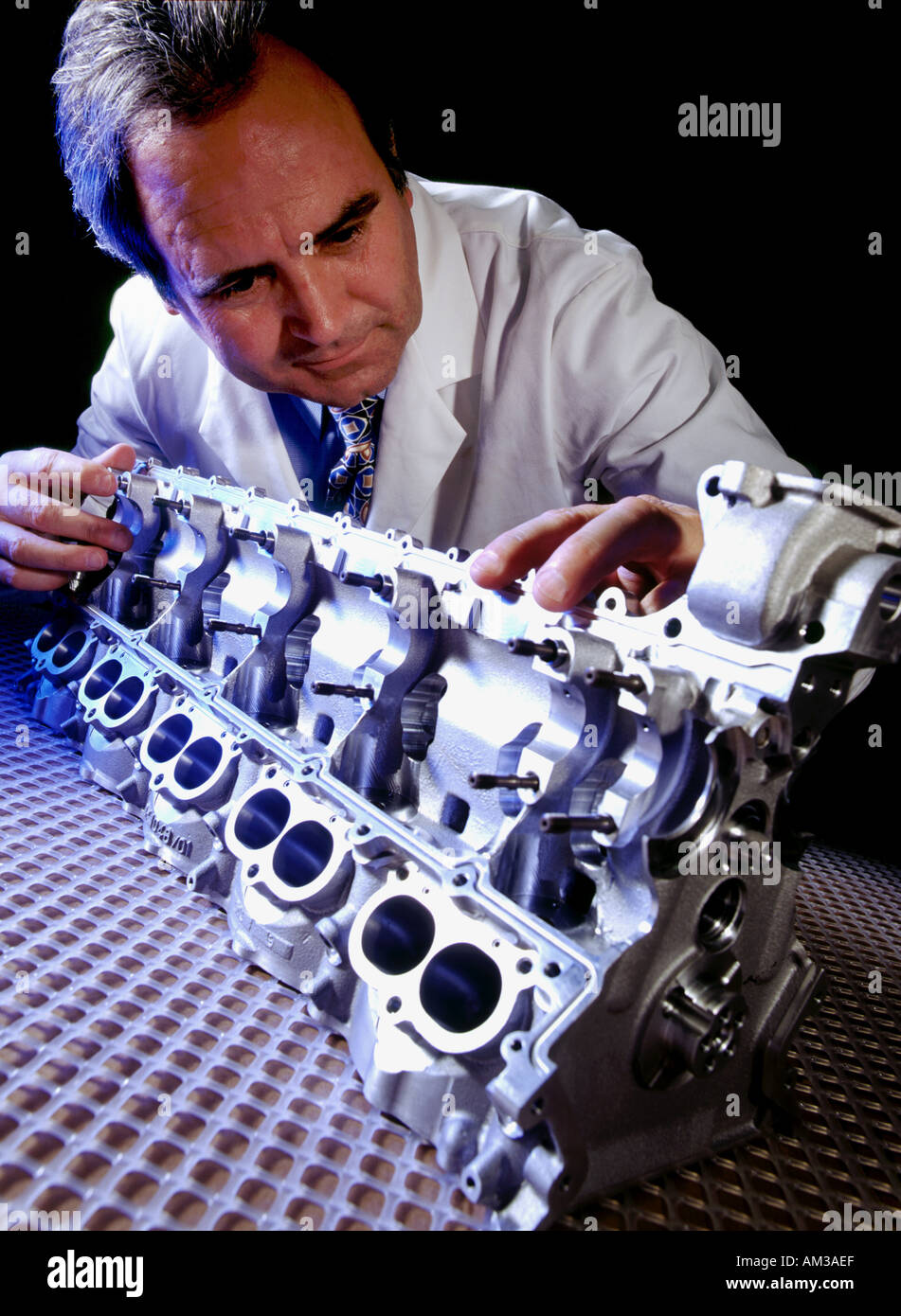 Engineer inspecting a new engine block Stock Photo - Alamy
