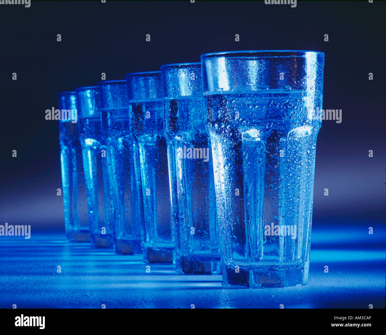 drinking water glasses filled with water on blue background Stock Photo ...