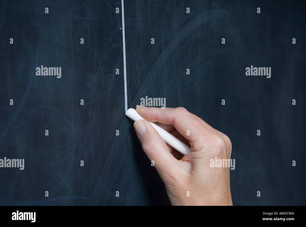 Teacher writing a line on a blackboard Stock Photo - Alamy