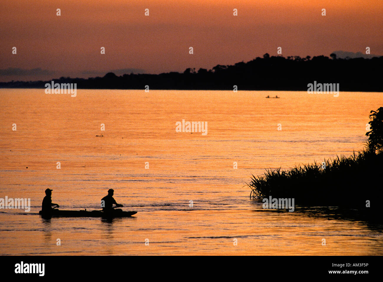 Dugout canoe at sunset on Amazon River, taken at Explorama Lodge ...
