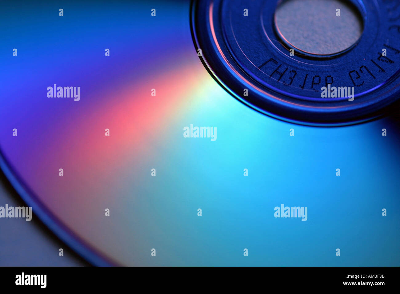 Abstract blue CD DVD close up against a blue background Stock Photo - Alamy
