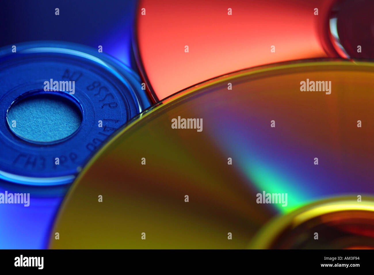 Abstract CDs DVDs close up against a blue background Stock Photo - Alamy