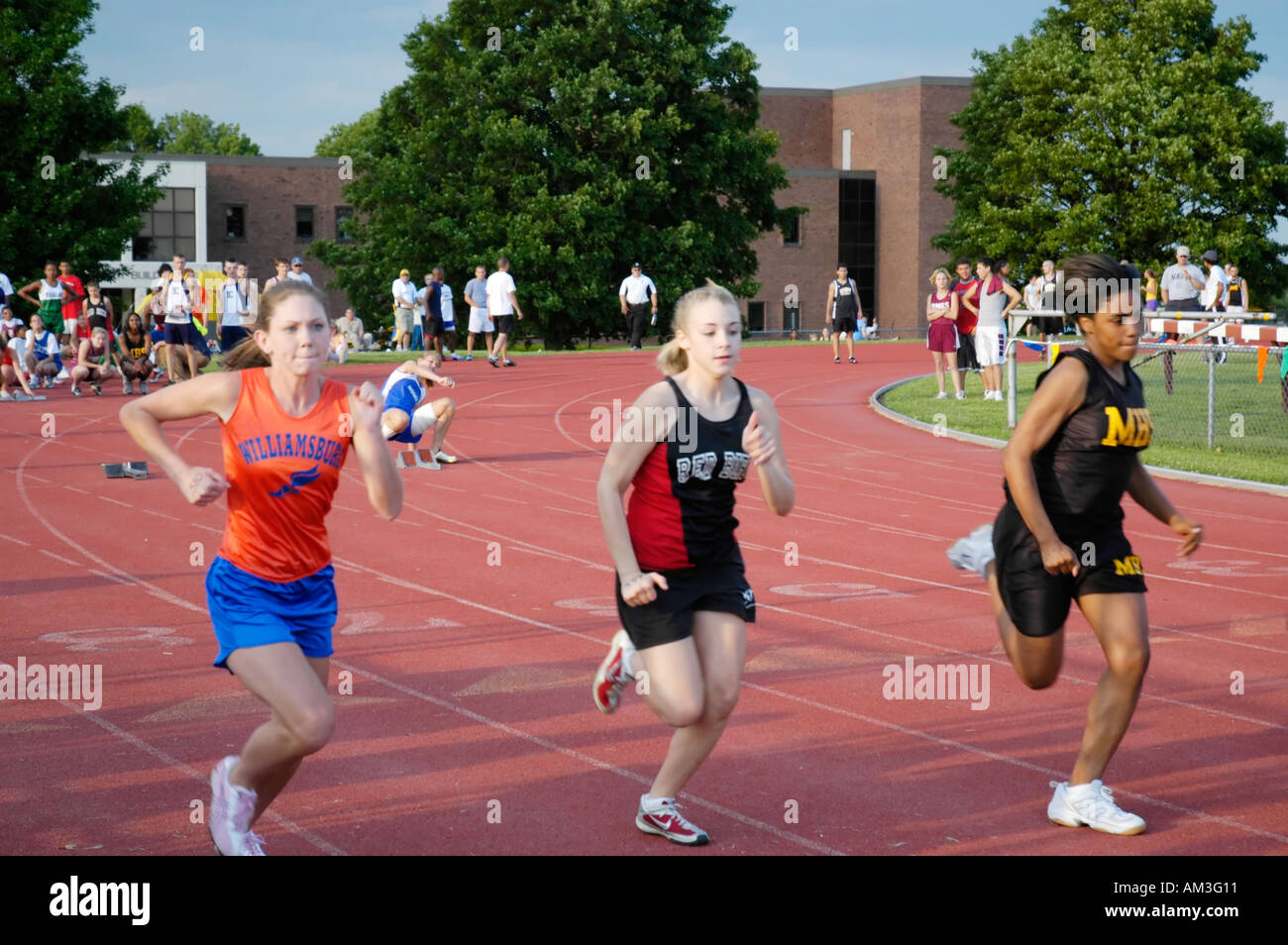 Teenage girl runners at a high school track and field district meet ...