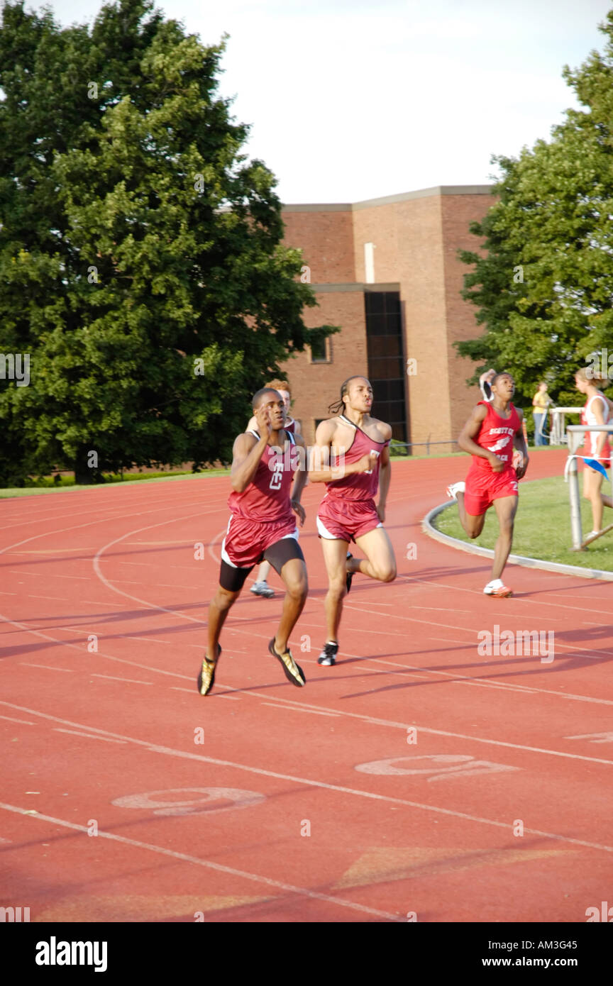 Teenage boy runners at a high school track and field district meet ...