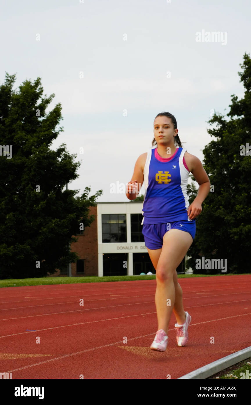 Teenage girl runner at a high school track and field district meet ...