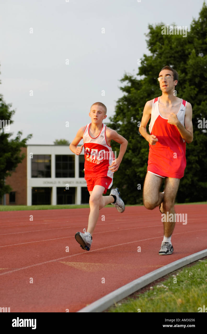 Teenage boy runners at a high school track and field district meet ...