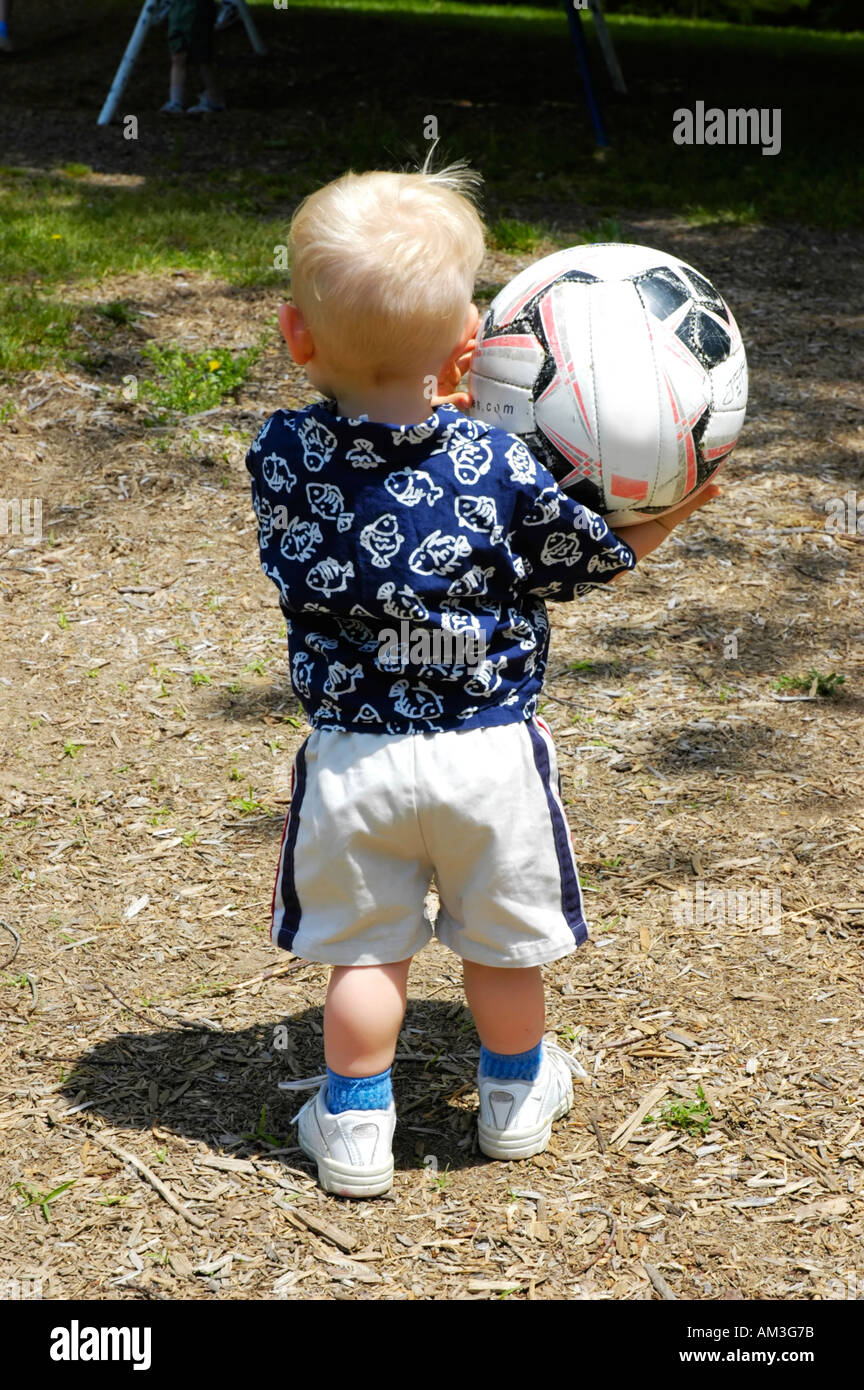 View of the back of a young toddler boy holding a soccer ball Stock ...