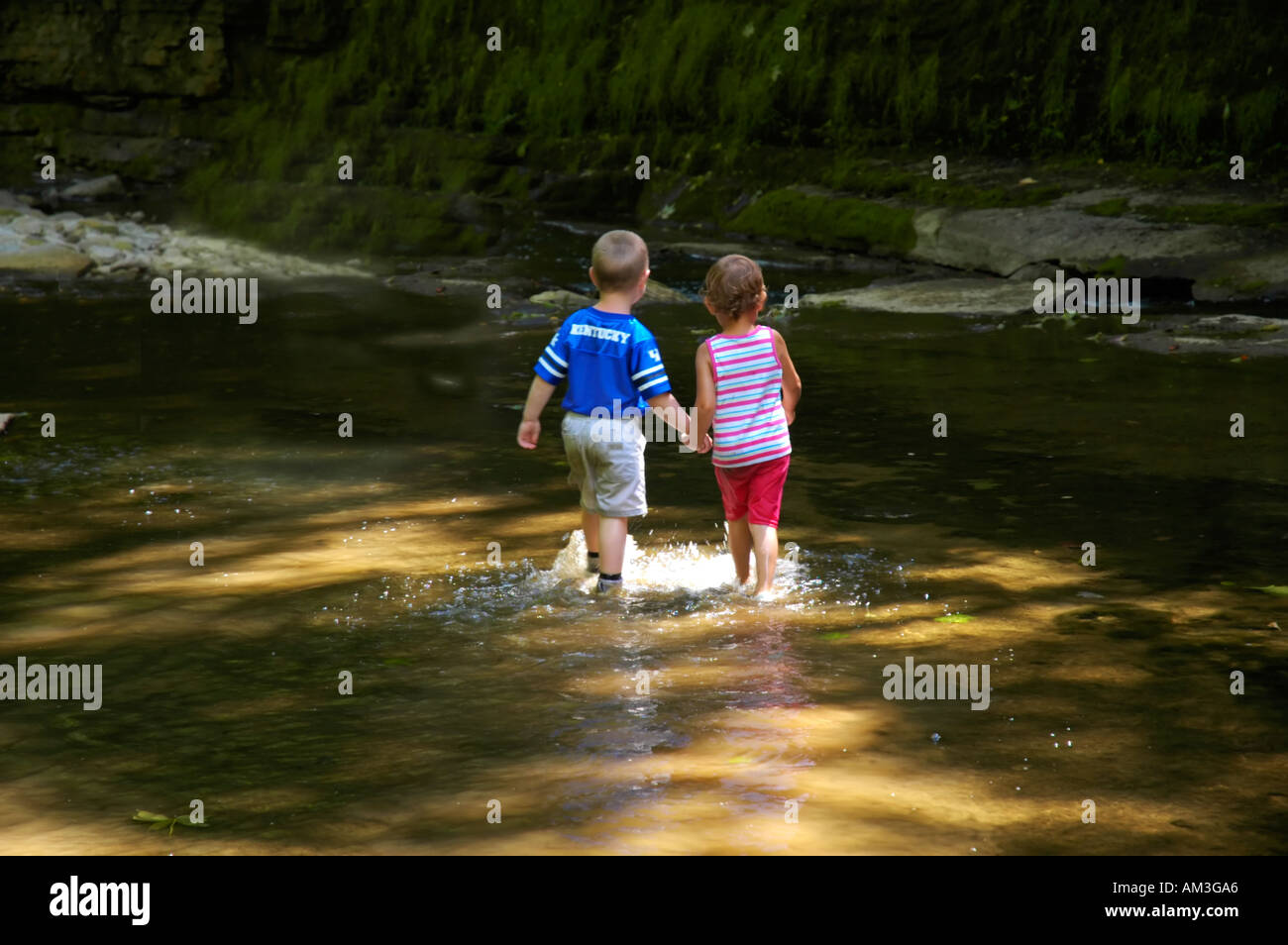 Boy girl wading in water hi-res stock photography and images - Alamy