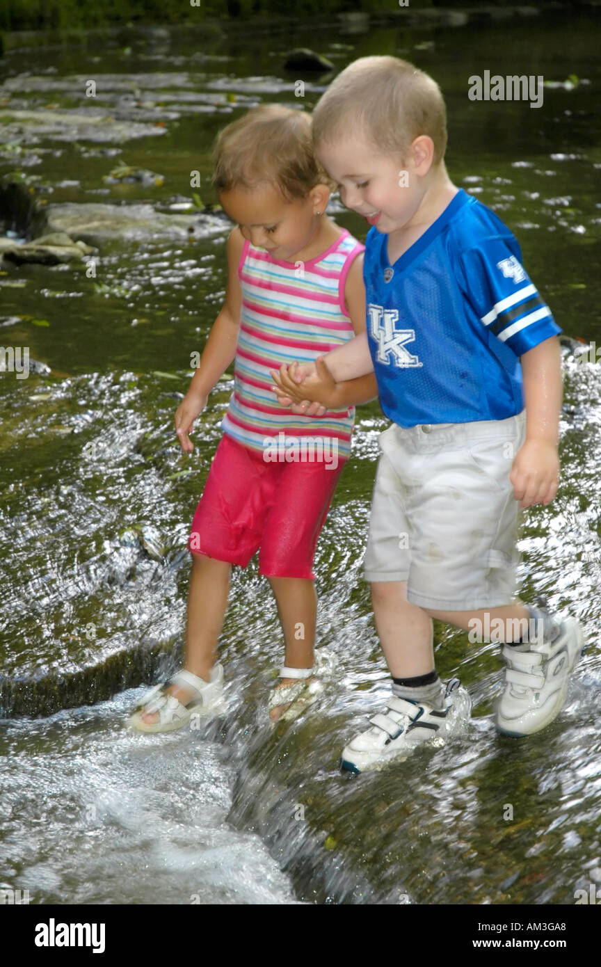 Boy girl wading in water hi-res stock photography and images - Alamy