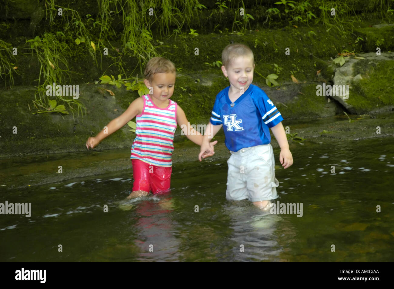 Boy girl wading in water hi-res stock photography and images - Alamy