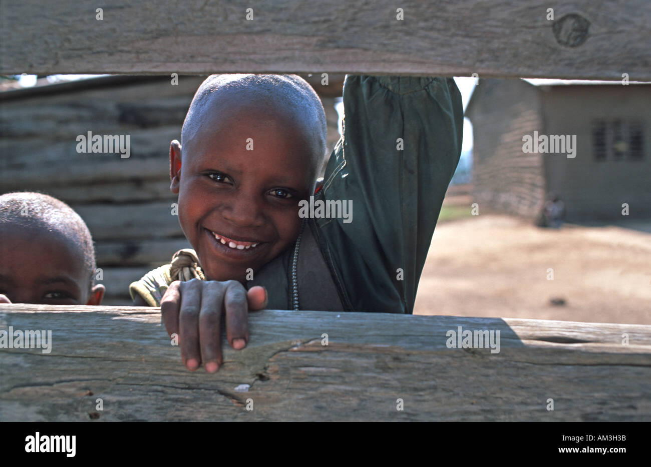 Masai boys behind a wooden fence North of Arusha en route to southern ...