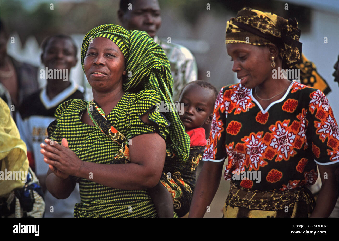 Women in colourful Tanzanian costume greeting a VIP arrival at ...