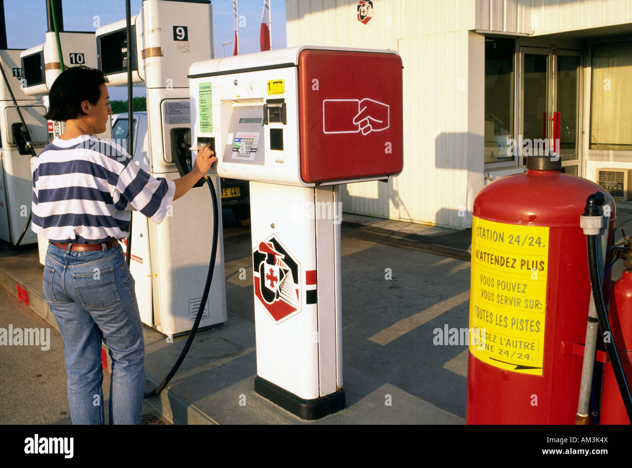 A woman pumps gasoline at a service station in Vannes France Stock ...