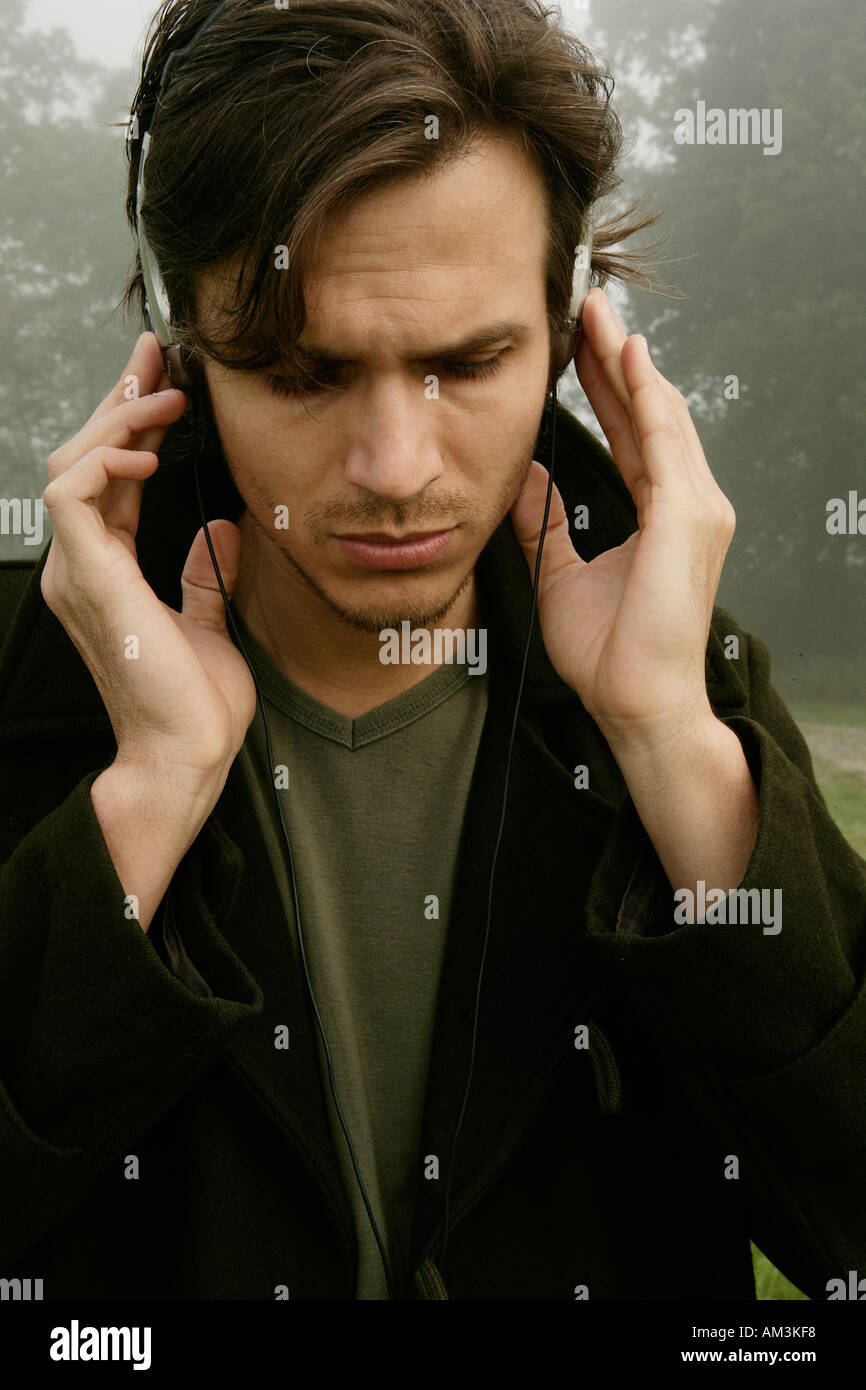 Man listening music earphones personal hi-res stock photography and ...