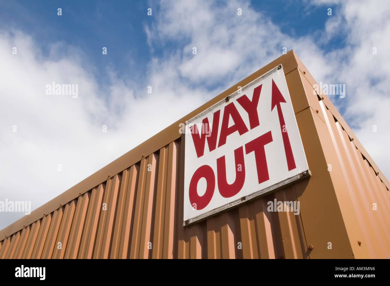 A WAY OUT sign in red lettering on the side of a shipping container ...
