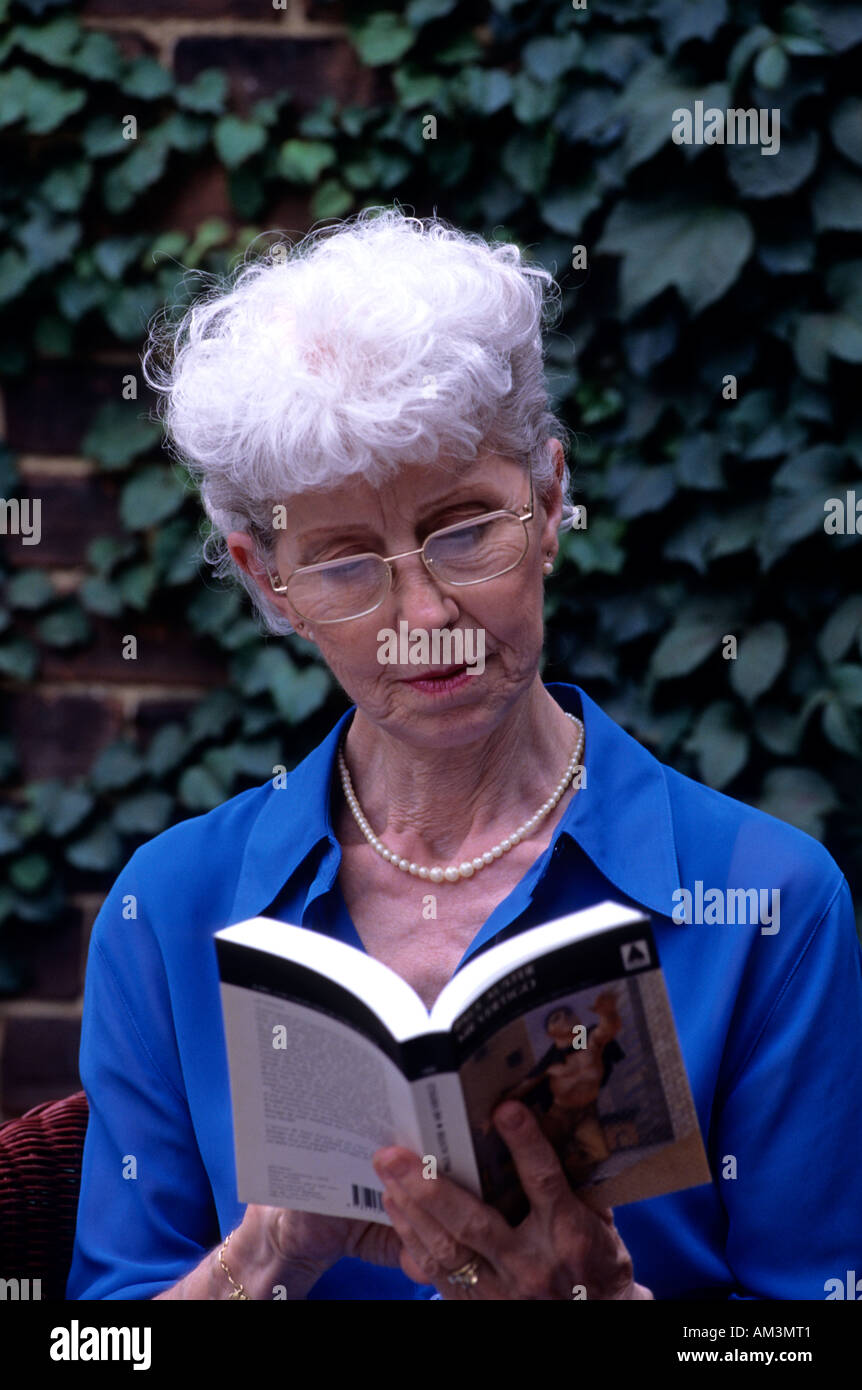 Senior reading a book Stock Photo - Alamy